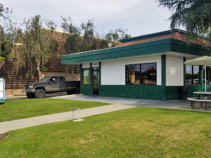That green and white exterior isn't just charming – it's your first hint that serious comfort food awaits inside. 