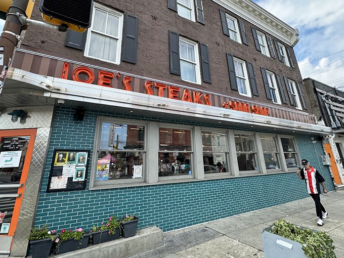 That iconic neon sign and turquoise tile exterior isn't just eye-catching—it's a time machine disguised as a corner shop in Philadelphia.