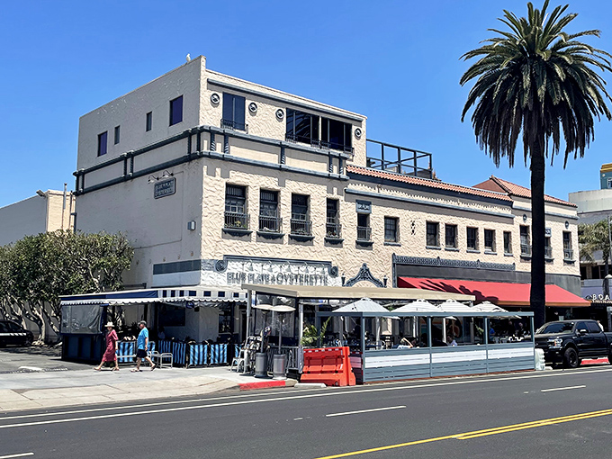 The blue and white striped awnings aren't just charming—they're practically waving "come eat something delicious" in maritime flag code.
