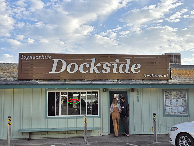 The entrance to seafood paradise! Palm-flanked doorway beckons hungry travelers into Dockside's unassuming sanctuary of oceanic delights.