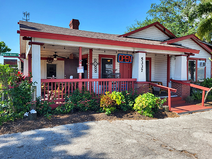 Old Florida charm doesn't get more authentic than this red-trimmed cracker house. The neon "OPEN" sign might as well say "Seafood Paradise Found."