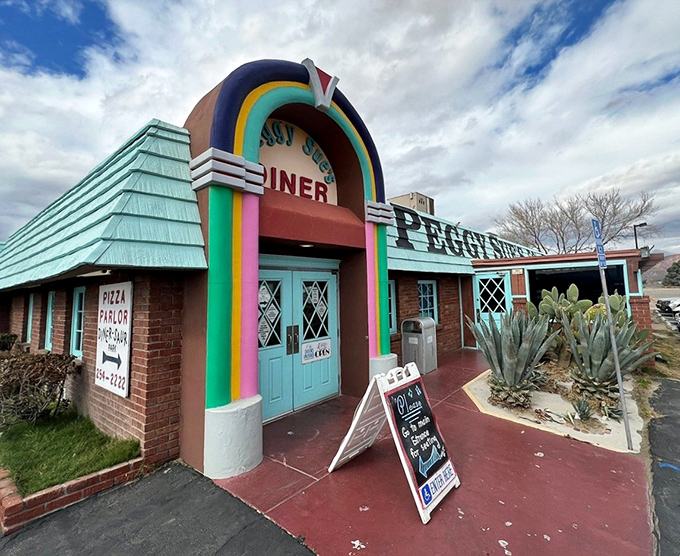 That rainbow-arched entrance isn't just a doorway—it's a time portal to an era when Elvis was king and milkshakes came with the metal mixing cup.