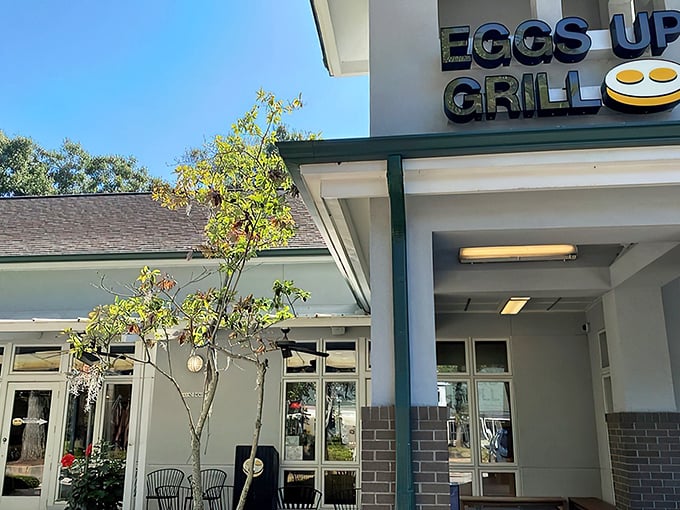 The inviting exterior of Eggs Up Grill beckons with its cheerful sign and welcoming porch – like a breakfast lighthouse guiding hungry souls to shore.