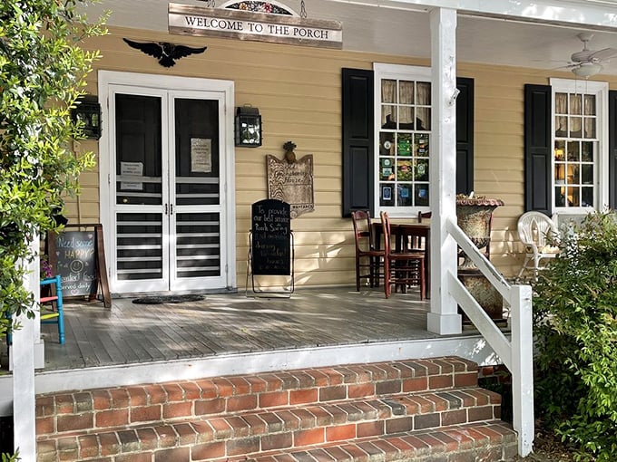 The porch says "Welcome" and means it. That bright blue rocking chair isn't just furniture—it's an invitation to slow down and savor what's coming. 