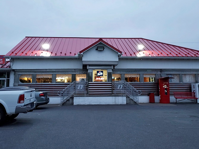 The classic red-roofed diner stands like a time capsule in Plains, Pennsylvania – a beacon of breakfast hope for hungry travelers and locals alike.