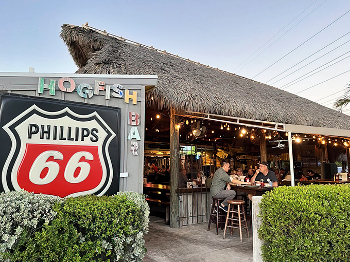 The thatched roof and Phillips 66 sign might make you think you've taken a wrong turn, but trust me—paradise awaits beneath that palm-thatched canopy.