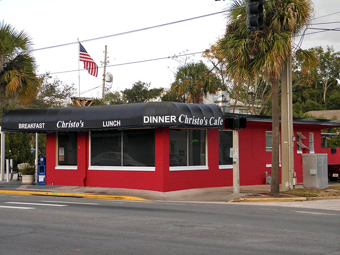 The unmistakable red exterior of Christo's Café stands out like a culinary lighthouse, beckoning hungry travelers with promises of breakfast bliss in Orlando.