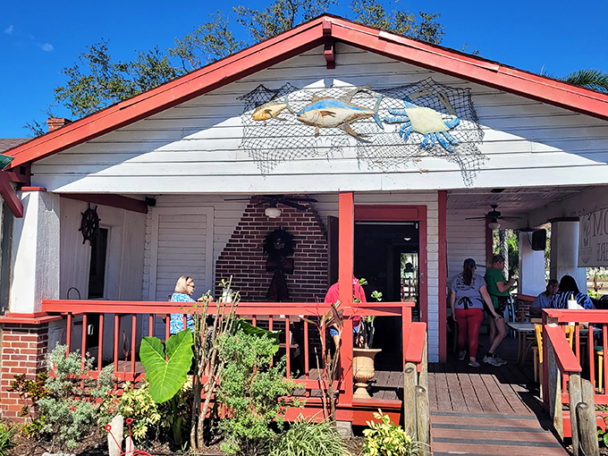 A classic Florida cracker house transformed into seafood heaven. The red-trimmed porch practically whispers "come on in" to hungry passersby.