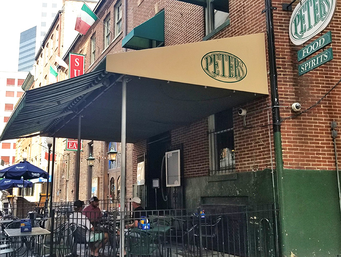 The unassuming brick exterior of Peter's Pour House beckons with its classic green awning and Irish flag—a culinary treasure hiding in plain sight.