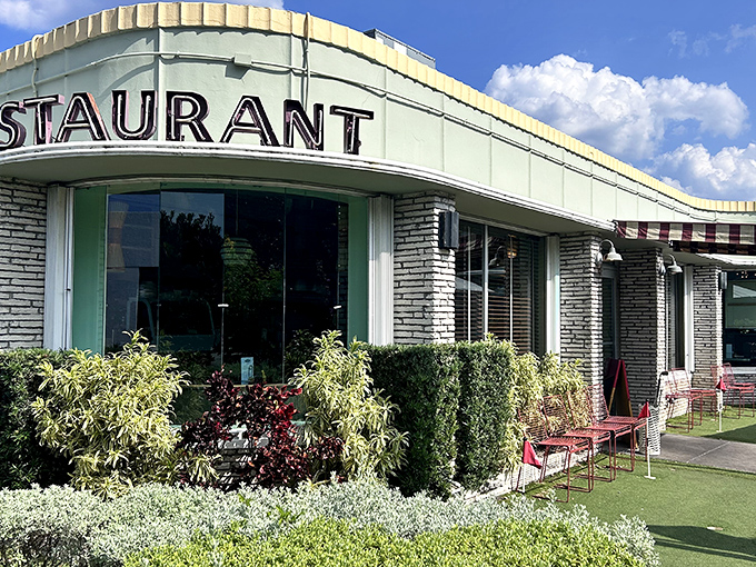 The mid-century modern façade of Howley's stands as a time capsule of Florida cool, complete with lush landscaping that says "come in, relax, you've found your happy place."