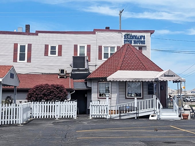The unassuming exterior of Brennan's Fish House stands like a maritime sentinel in Grand River, complete with its iconic red-roofed turret and welcoming porch.