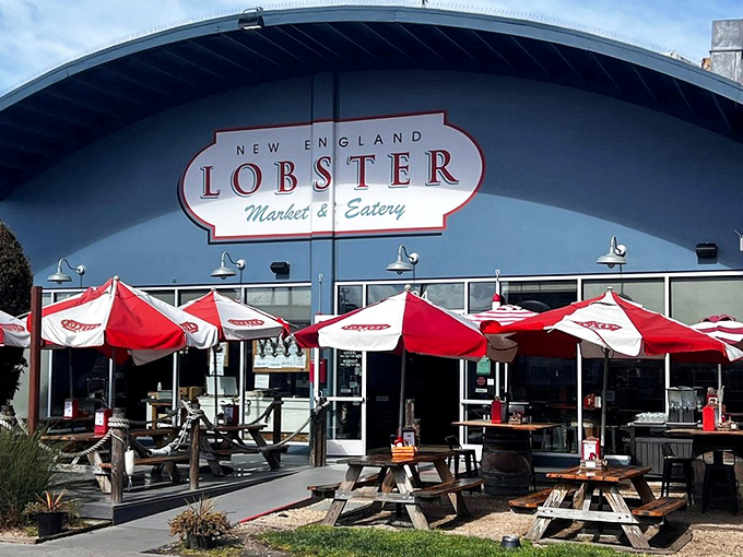The bright blue facade with those cherry-red umbrellas is like a coastal siren song, beckoning seafood lovers to drop anchor and feast.
