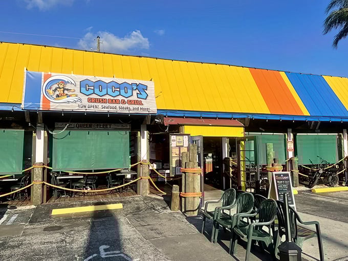 The sunshine-yellow exterior of Coco's isn't just a building—it's a mood announcement. Florida casual meets Maryland seafood tradition under those blue Surfpind umbrellas.