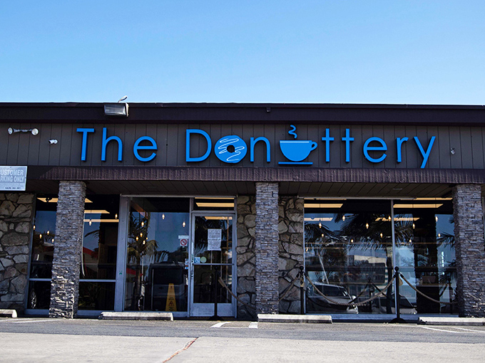 The blue neon sign beckons like a lighthouse for the sweet-toothed, promising donut nirvana behind those unassuming doors.