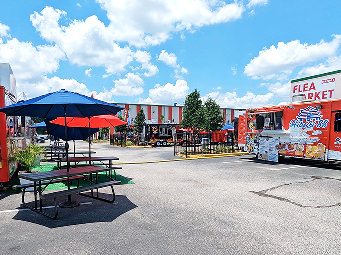 The distinctive orange-framed entrance to Main Gate Flea Market stands like a retail lighthouse, beckoning bargain hunters to the treasures within.