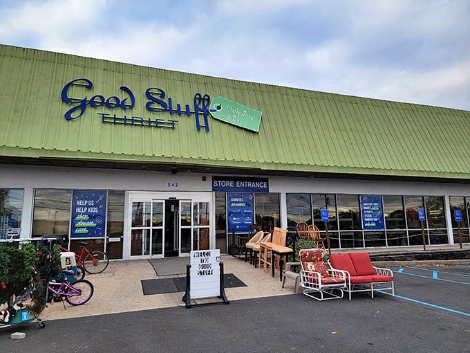 The green exterior of Good Stuff Thrift beckons like a treasure chest waiting to be opened, with outdoor furniture teasing what awaits inside.