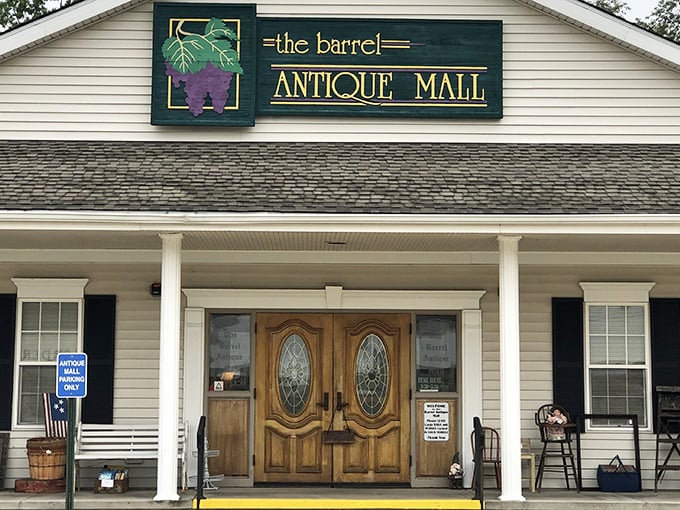 The welcoming facade of The Barrel Antique Mall beckons with its charming porch and elegant wooden doors—a modest exterior that belies the wonderland within.