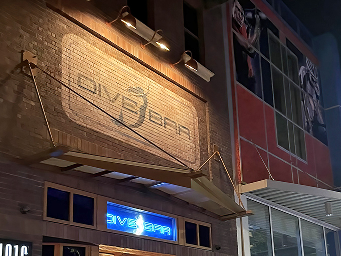 The brick facade of Dive Bar beckons with its illuminated mermaid logo – Sacramento's answer to "what if Ariel opened a cocktail lounge?"