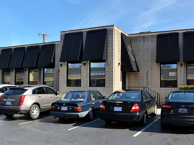 The yellow brick exterior with its distinctive black awnings and red neon lighting transforms into a beacon of comfort food possibilities after dark.