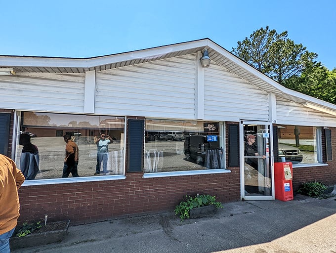 The yellow sign says it all – this unassuming brick building houses burger magic that locals have treasured for decades.