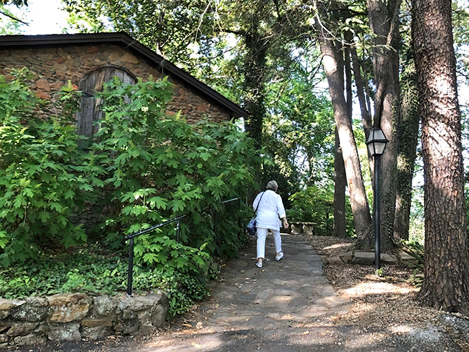 A stone cottage nestled among towering trees isn't just fairy tale scenery—it's your first clue that The Peddler isn't your average strip mall steakhouse.