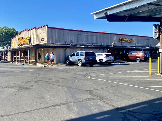 The unassuming exterior of Cattlemens in Dixon might fool you, but that wagon wheel isn't just for show—it's your first clue to the authentic Western feast awaiting inside.
