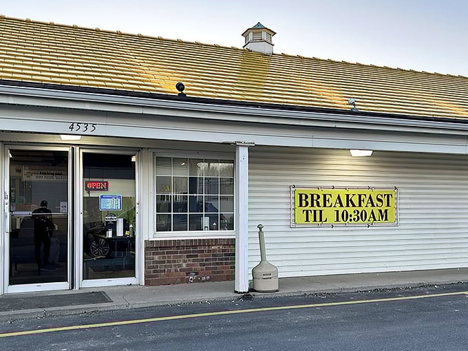 Bold white lettering against classic siding proudly declares what locals already know – this modest building houses chicken perfection worth crossing roads for.