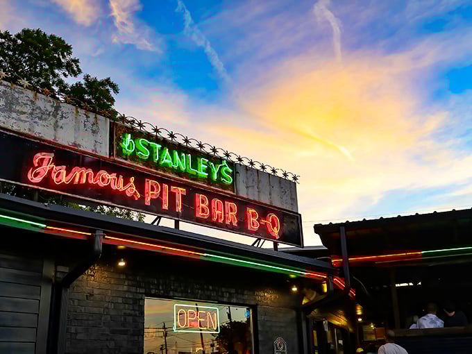 That neon glow against a Texas sunset isn't just a sign—it's a beacon of barbecue hope calling hungry pilgrims home.