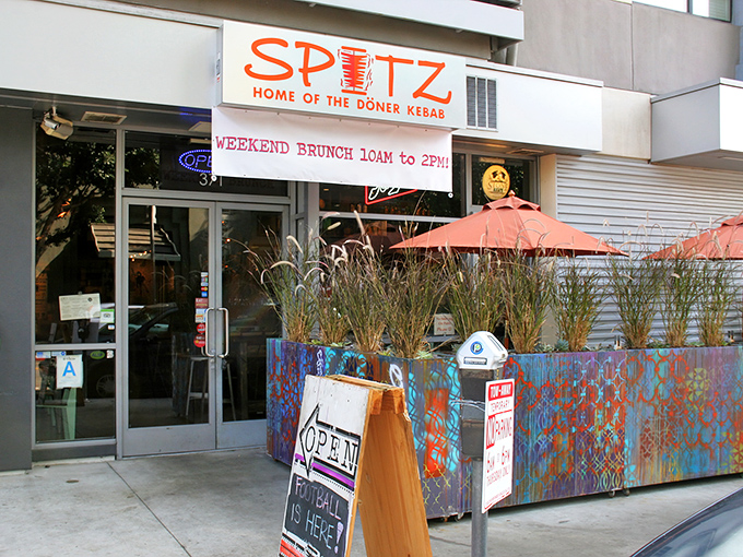 Spitz announces itself with vibrant confidence – colorful planters, coral umbrellas, and a promise of döner kebabs that'll make your taste buds stand at attention.