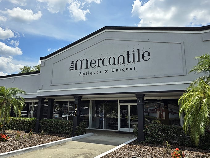 The white facade gleams like a treasure chest in the Florida sun, palm trees standing guard at the entrance to vintage paradise.