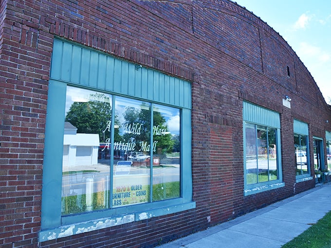 The unassuming brick exterior houses a universe of treasures inside—like finding Narnia in a closet, but with more vintage toasters.