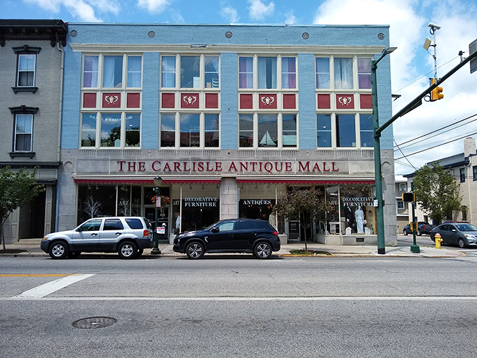 The blue façade of Carlisle Antique Mall stands like a portal to the past, inviting treasure hunters to step through its doors and back in time.