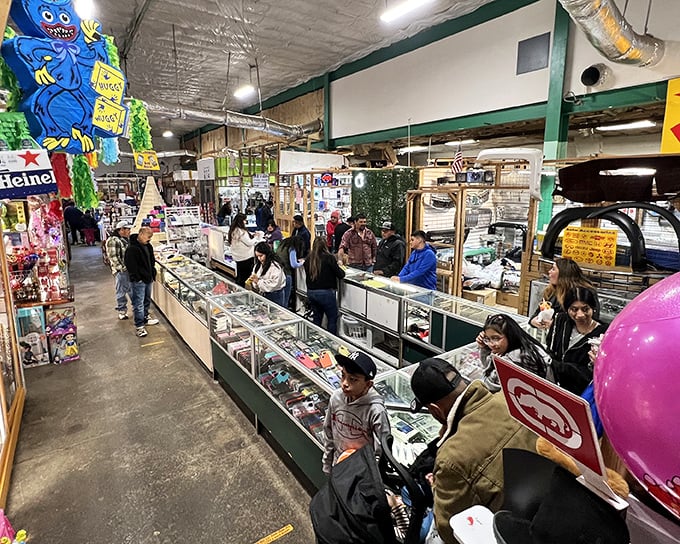 Glass display cases become treasure chests at Durham Green Flea Market, where shoppers hunt for collectibles while colorful piñatas stand guard overhead.