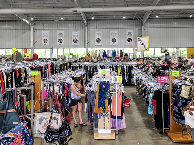 Treasure hunters navigate a sea of clothing racks under soaring ceilings. This isn't just shopping—it's an expedition with purpose.