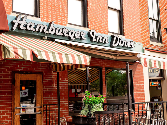 The unassuming storefront of Hamburger Inn Diner beckons with its vintage charm and green-striped awning – a time portal to simpler, more delicious days.
