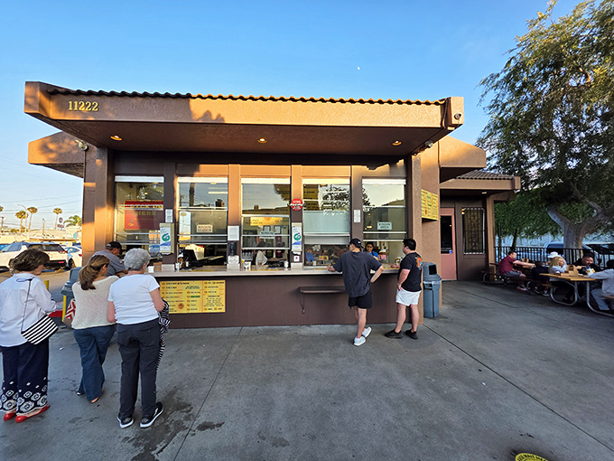The pilgrimage begins here: Tito's iconic brown stucco exterior, where Angelenos have been lining up for decades to satisfy their hard-shell cravings.