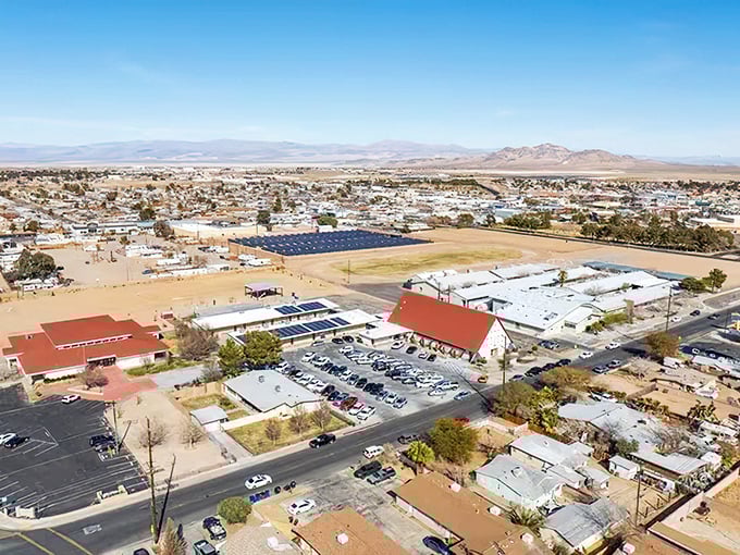 Ridgecrest sprawls beneath vast desert skies, where red-roofed homes dot the landscape like terracotta islands in a sea of sage and sand.