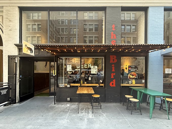 The Bird's unassuming storefront in San Francisco's Financial District beckons with its yellow cat logo—like a culinary lighthouse guiding hungry souls to fried chicken paradise.
