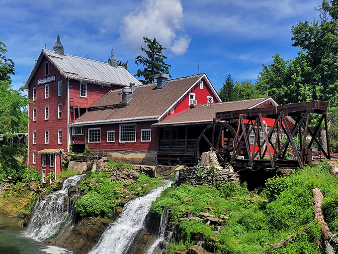 The iconic red mill perched above cascading waterfalls isn't just Instagram bait—it's a 200-year-old testament to when breakfast came with a side of history.