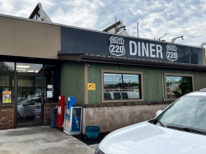The unassuming exterior of Route 220 Diner stands like a culinary lighthouse for hungry travelers – no fancy frills, just the promise of honest food inside.