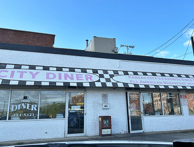 The classic black and white checkerboard awning of City Diner isn't just decoration—it's a beacon calling hungry souls to breakfast paradise in Kansas City.