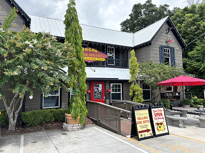 The charming gray cottage with its metal roof and lush greenery feels like stumbling upon a secret clubhouse for sandwich enthusiasts.