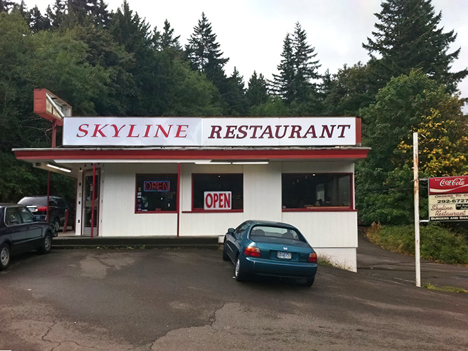 Nestled among towering evergreens, Skyline Restaurant's classic white-and-red exterior promises comfort food nirvana that time forgot—in the best possible way.