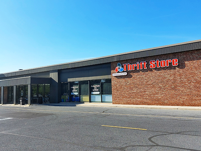 The unassuming brick exterior of CommunityAid belies the treasure trove within—like finding a portal to bargain heaven disguised as a strip mall storefront.