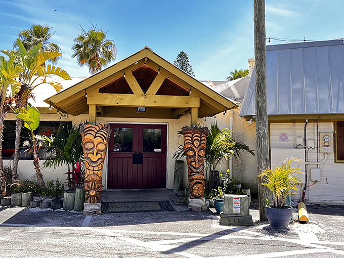 Tiki guardians flank the entrance to SeaBreeze Island Grill, promising tropical flavors and Florida vibes before you even step inside.