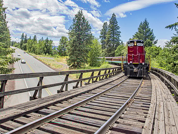 The iconic crimson and turquoise Mount Hood Railroad cuts through Oregon's wilderness like a living postcard, bringing nostalgic train travel and breathtaking scenery together in perfect harmony.