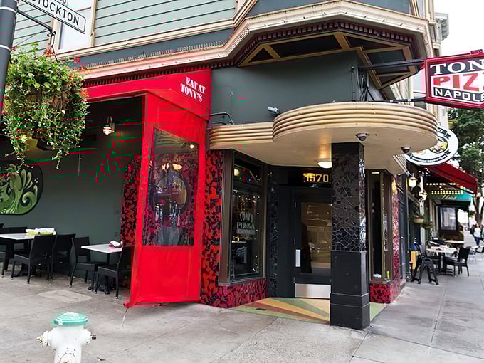 The mint-green Victorian with red awnings isn't just another pretty San Francisco facade—it's the gateway to pizza paradise that's worth every minute of the inevitable wait.