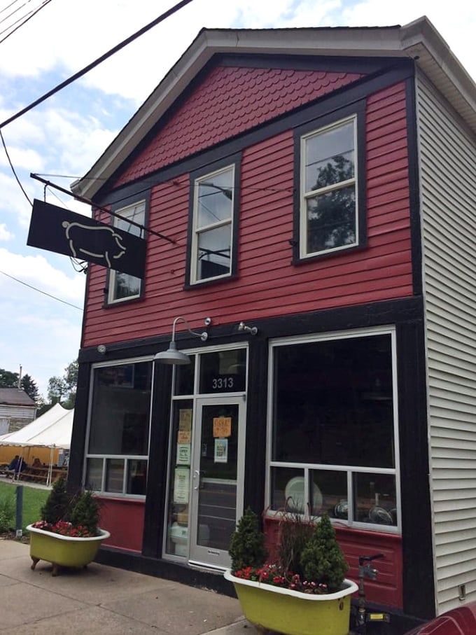 The unassuming burgundy exterior of Eli's BBQ stands like a beacon of hope for hungry travelers. Behind that modest facade lies smoky paradise.