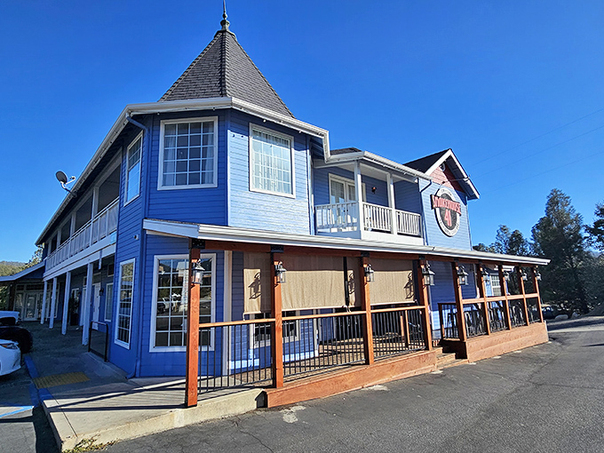 That blue Victorian charm meets serious barbecue business – where fairy tale architecture houses smoky dreams.