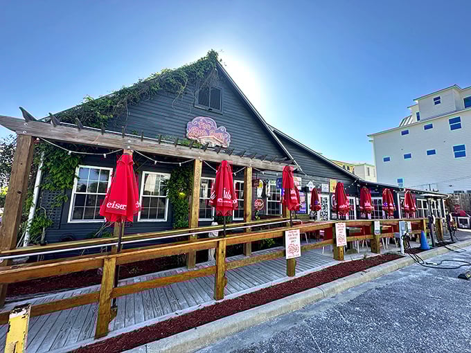 The unassuming exterior of The RedBar hides a culinary wonderland within. Those red umbrellas are like beacons calling hungry travelers home.